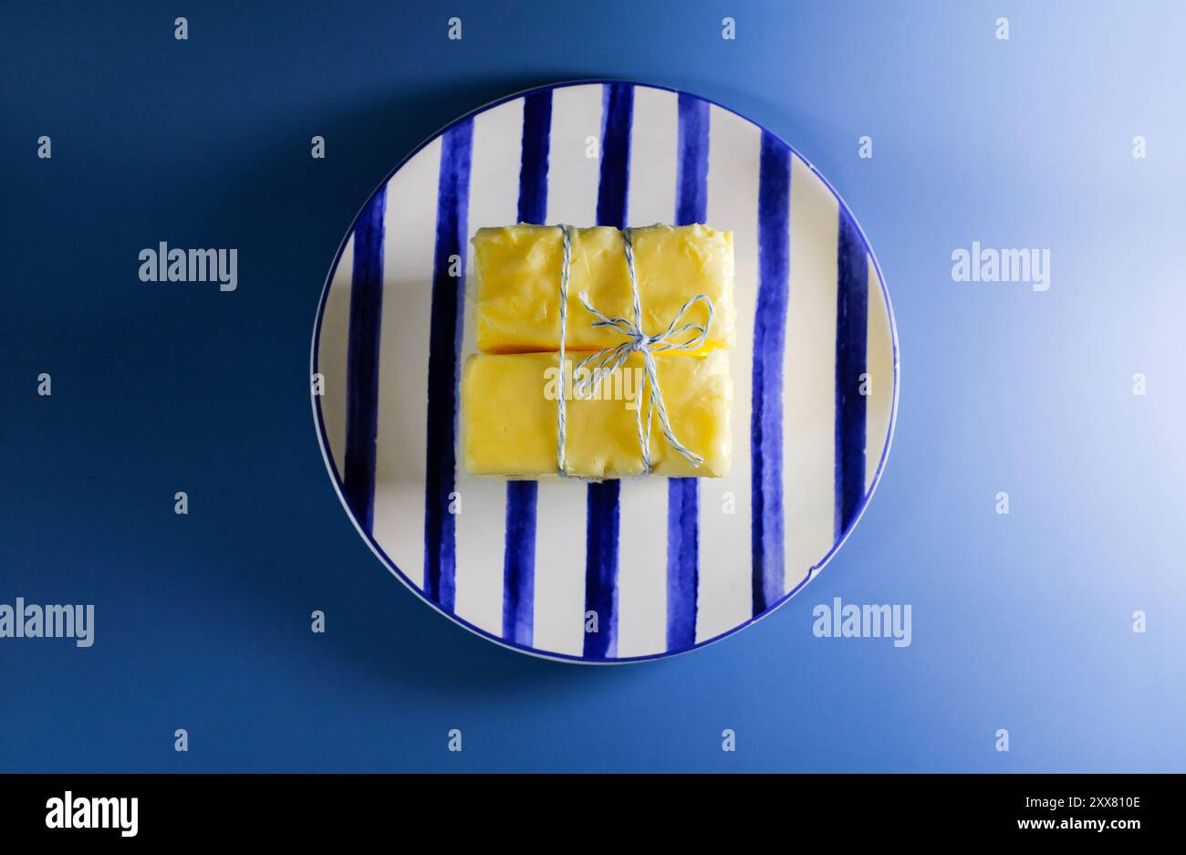 Sticks of Butter Wrapped in Blue and White String Stock Photo - Alamy