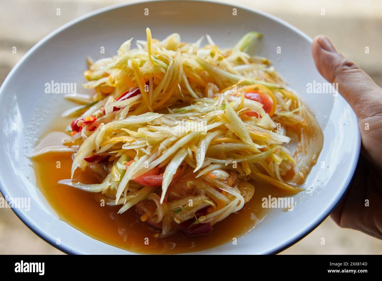 Spicy green papaya salad or Som Tum Thai food served on plate Stock ...
