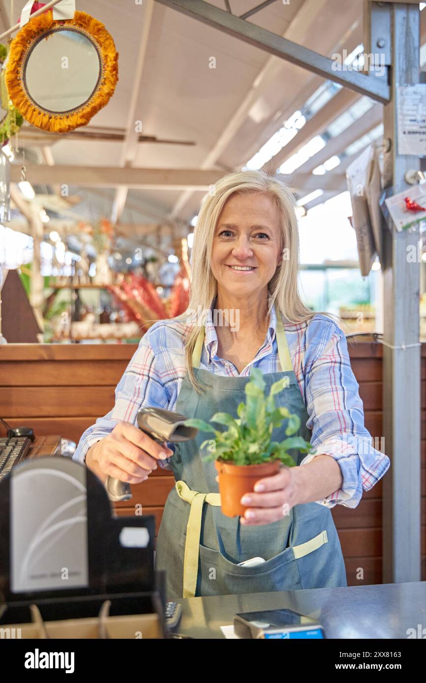 woman cashier's scanning the barcode of a product in a shop Stock Photo ...
