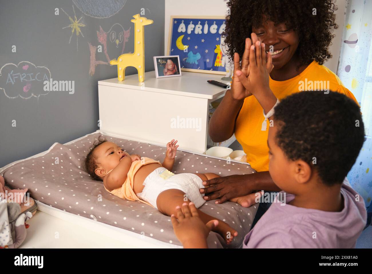Mother changing baby's diaper hi-res stock photography and images - Alamy