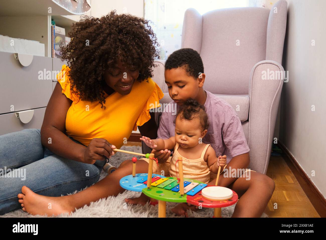 Happy family playing music together with a xylophone Stock Photo - Alamy