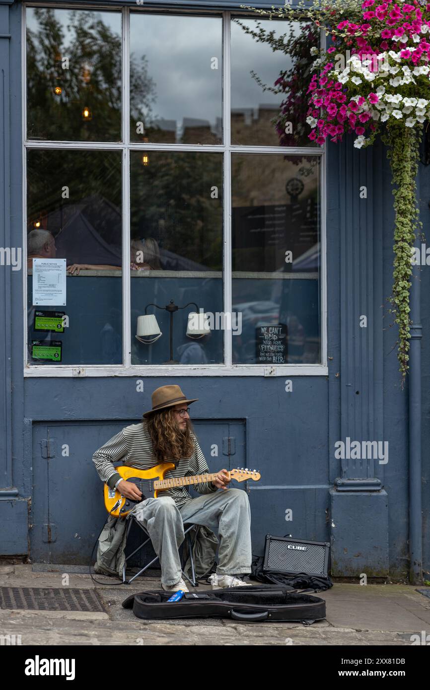 Street performer playing guitar outside a pub in Lincoln (England Stock ...