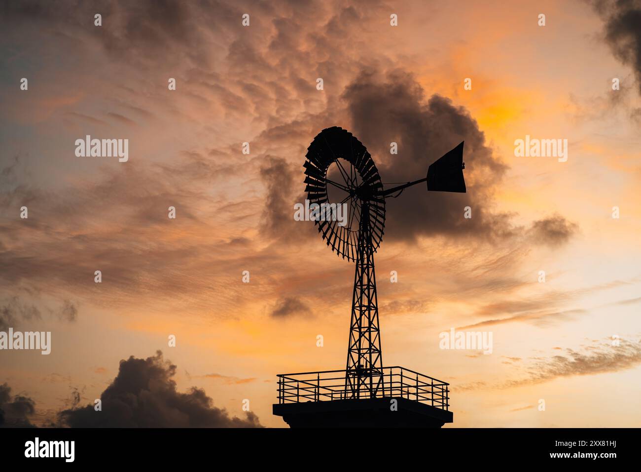 A windmill with the Flinders Ranges behind it during sunrise in Besut ...