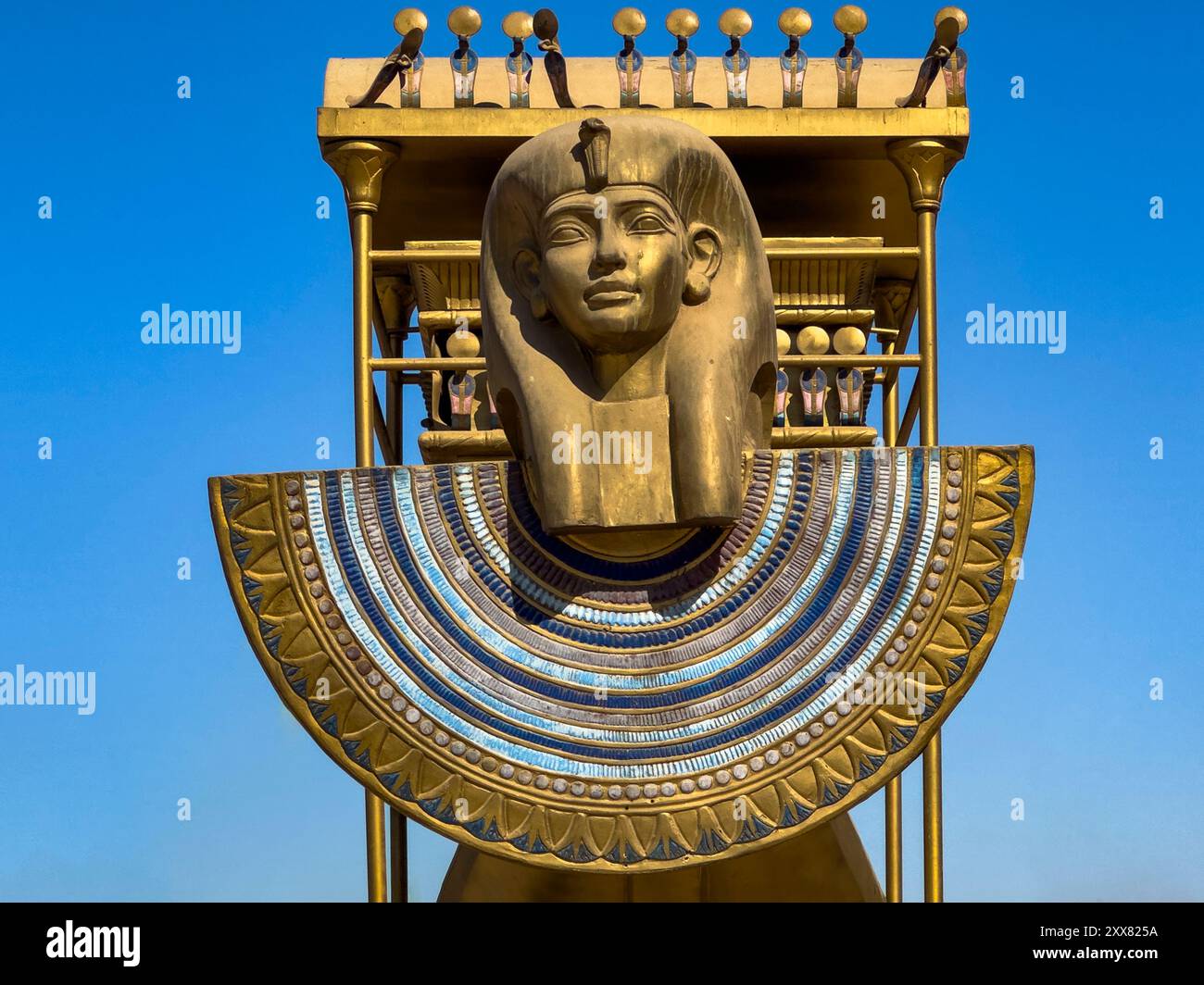 The intricately carved head of an Egyptian god or pharaoh graces the ...