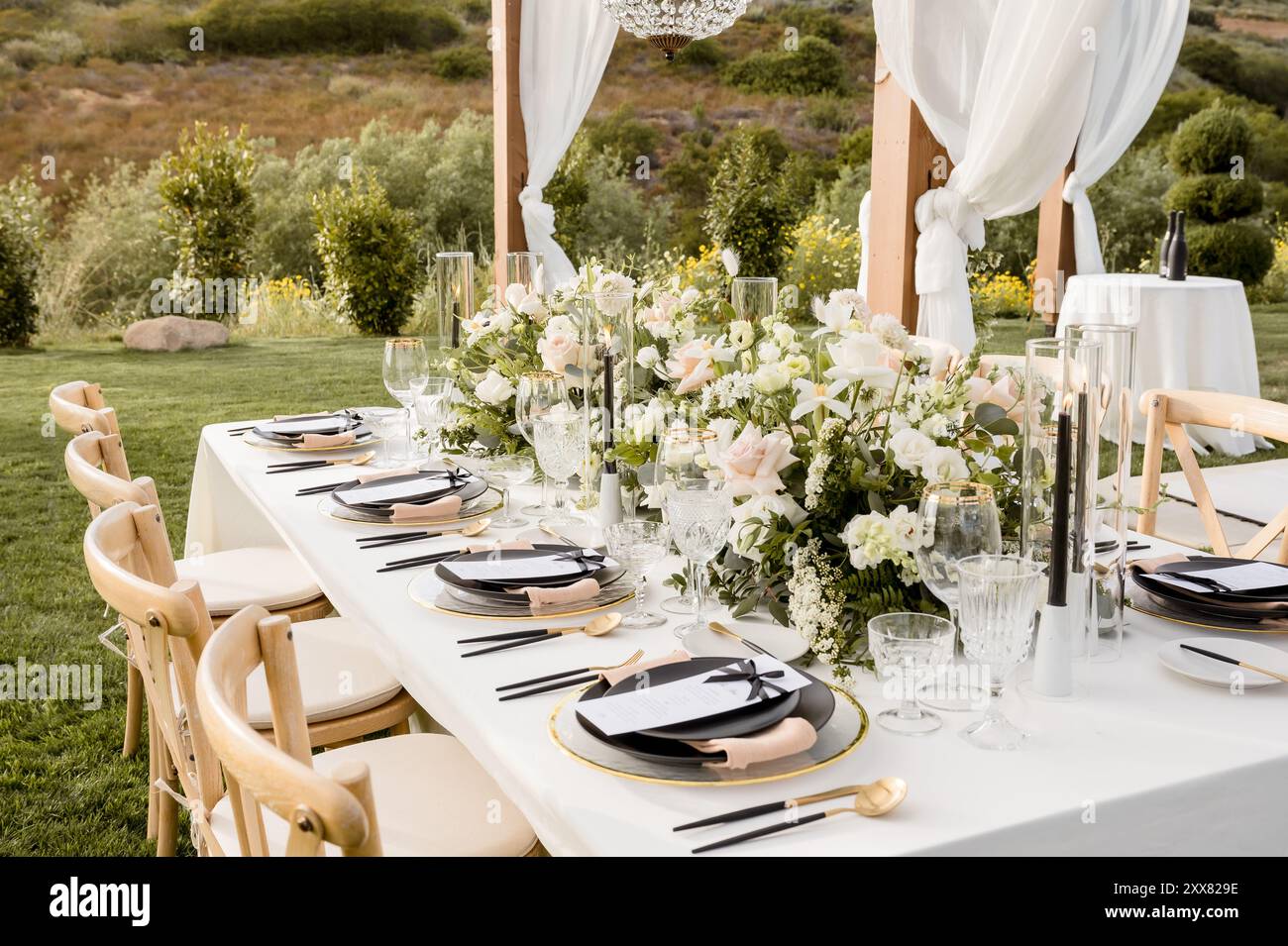 Outdoor wedding reception tablescape with lush florals and Stock Photo ...