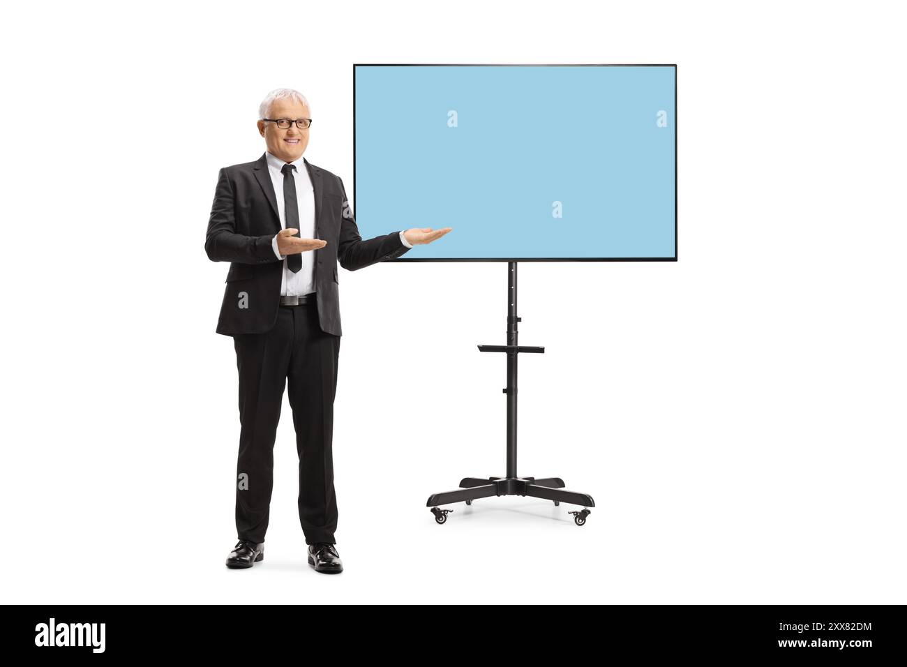 Mature man presenting in front of a tv on a stand isolated on white ...