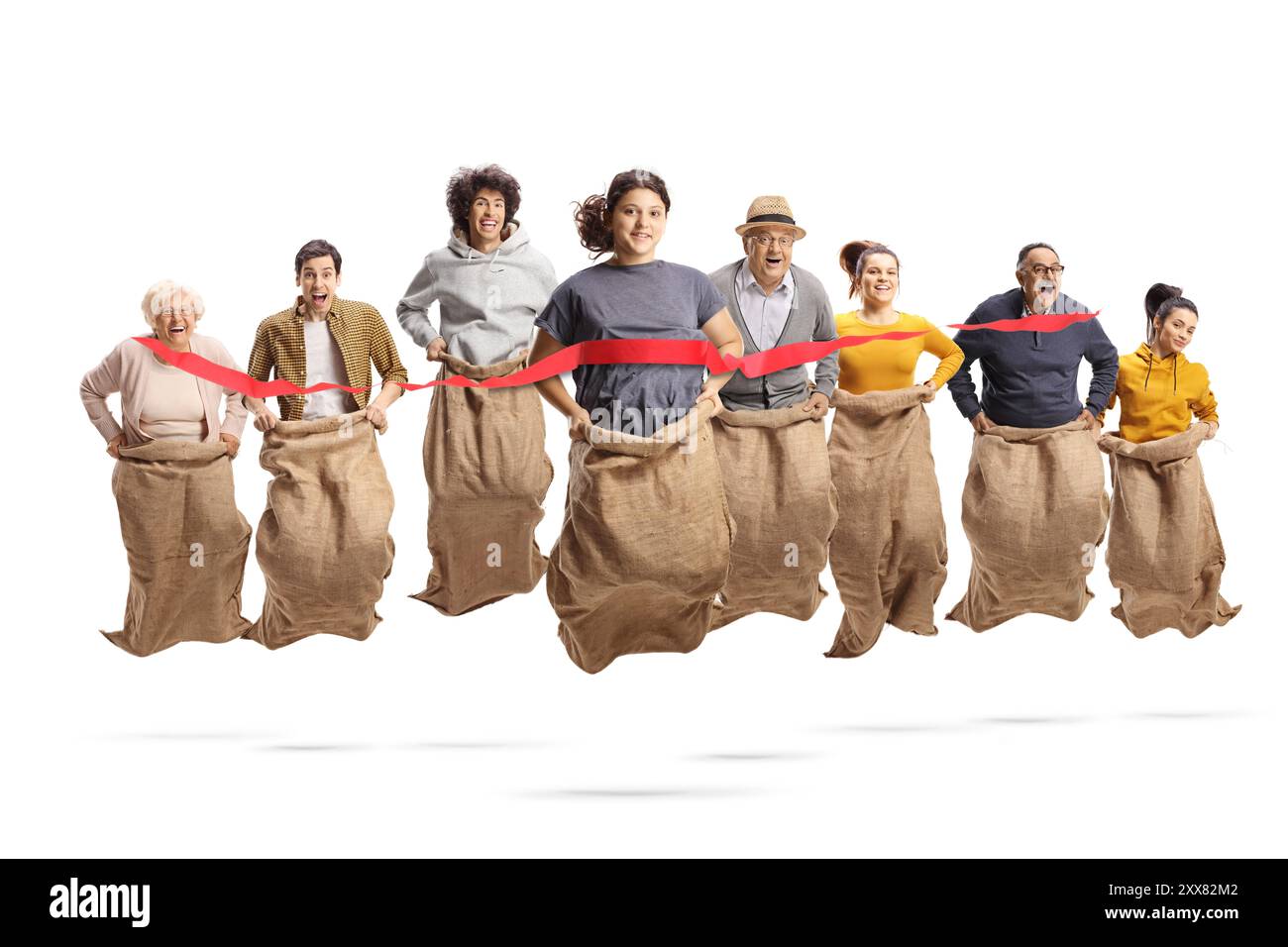 Group of young and older people in sacks at the finsih line of a race ...