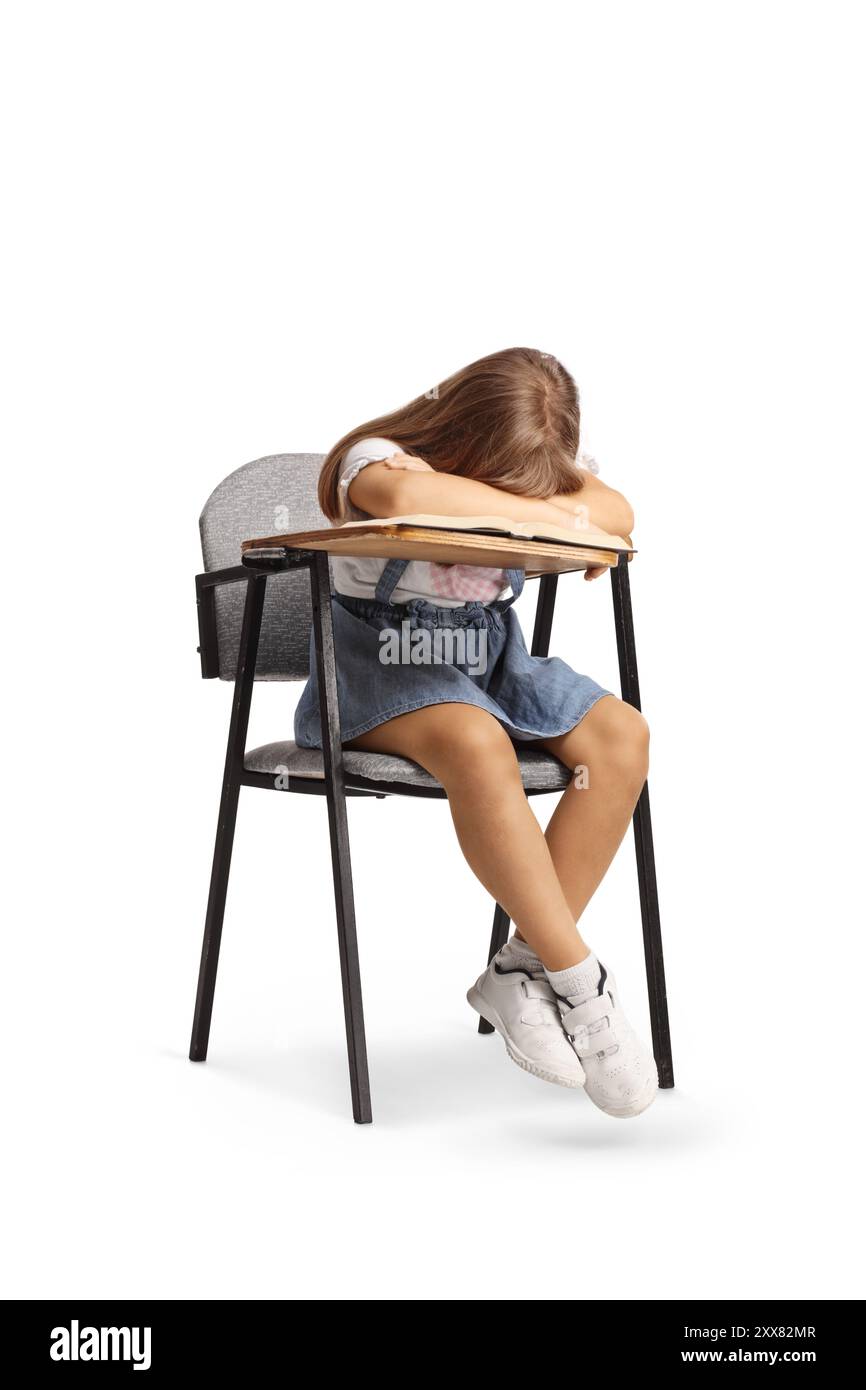 Tired little girl sleeping in a school chair isolated on white ...