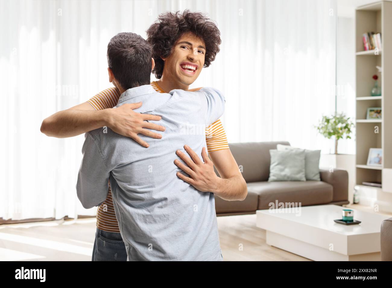 Two men hugging friendship hi-res stock photography and images - Alamy