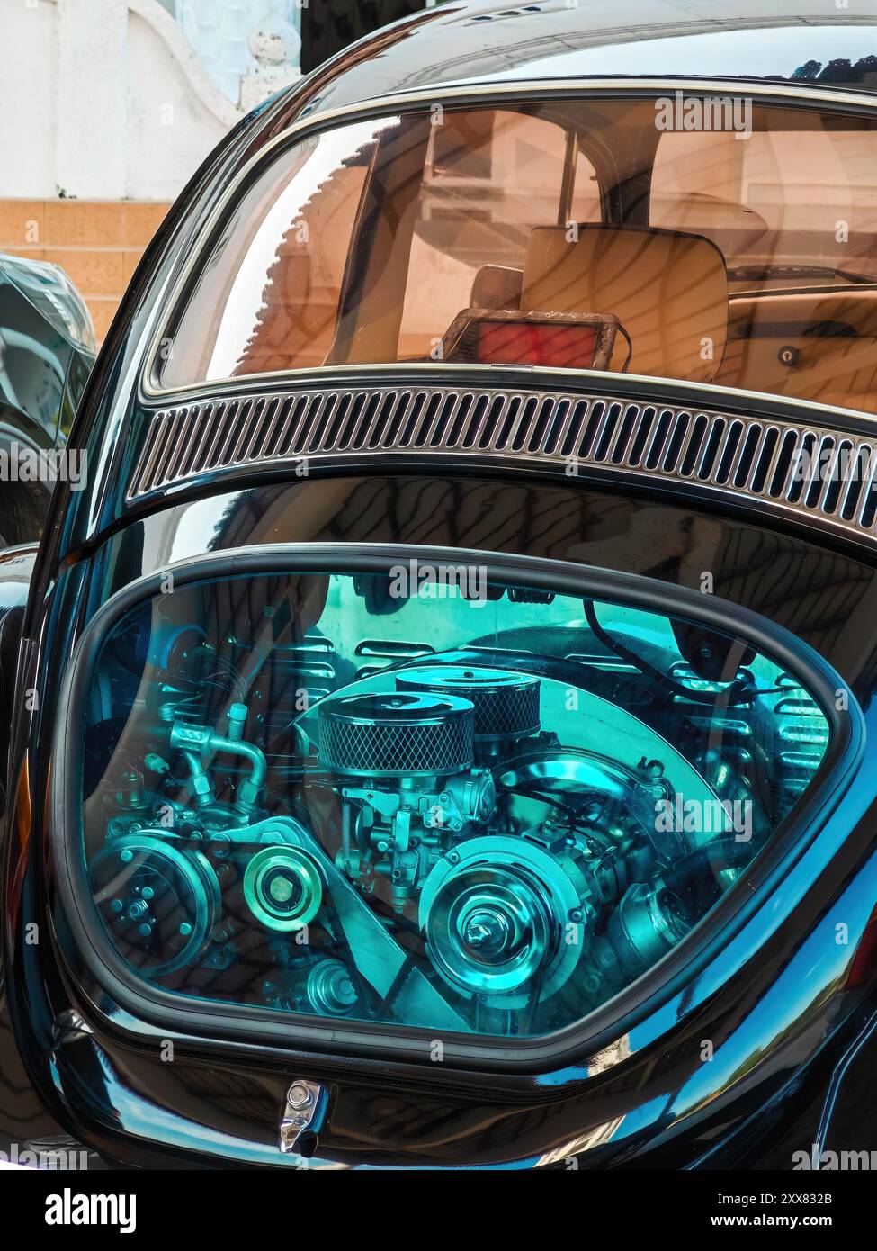 A vintage car showcasing its powerful engine through a transparent ...