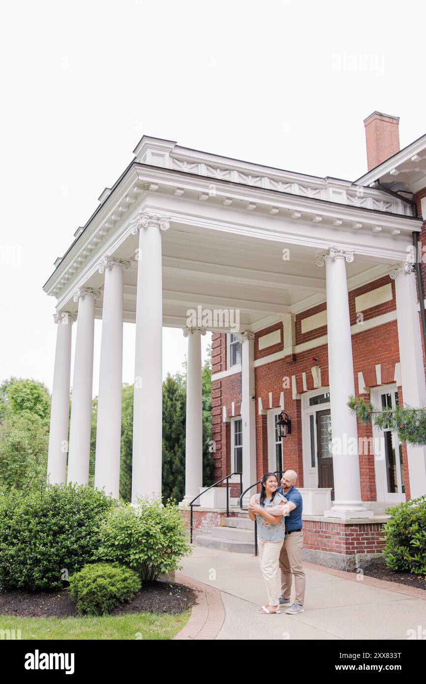 Interracial couple embracing near a historic building in Worcester, MA ...