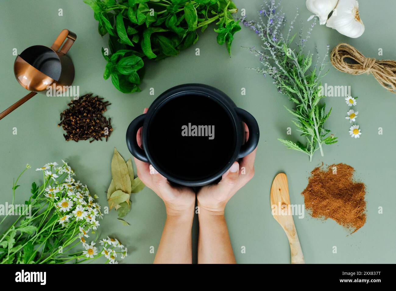 Overhead View of Hands Holding a small black cauldron Stock Photo - Alamy