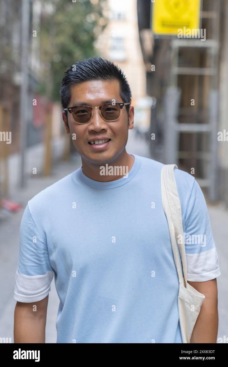 Portrait of young Asian man in the city Stock Photo - Alamy