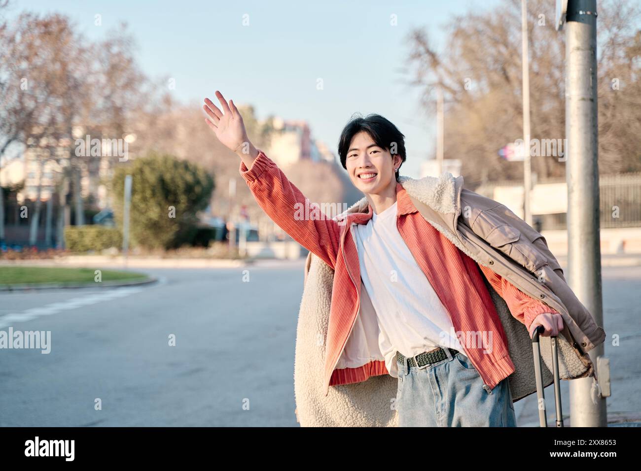 traveling asian chinese man calling for taxi cab from city street ...