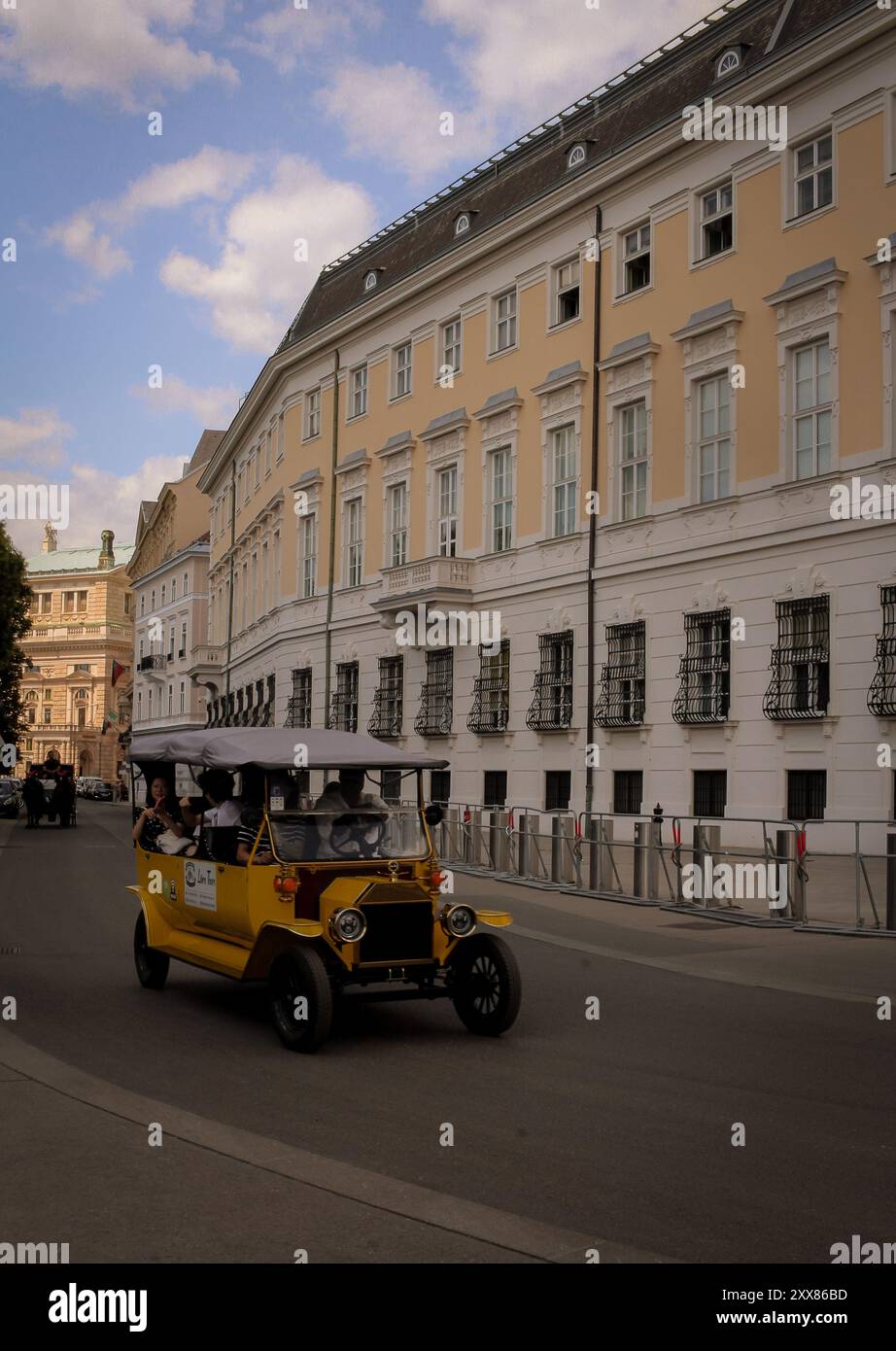 sightseeing tour in a vintage yellow car to vienna Stock Photo - Alamy