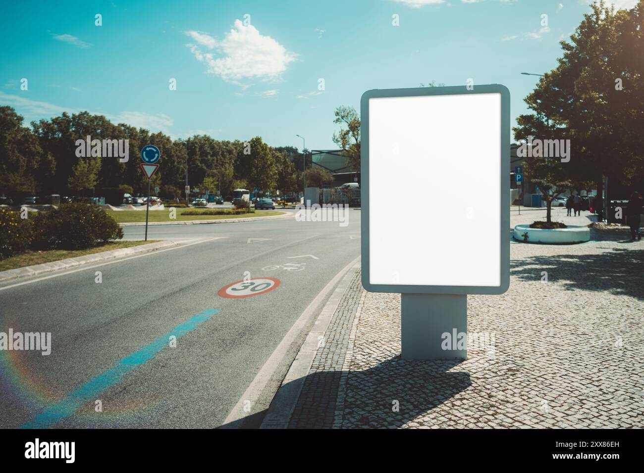 Outdoor billboard mockup on a roundabout, with a clear blue sky and ...