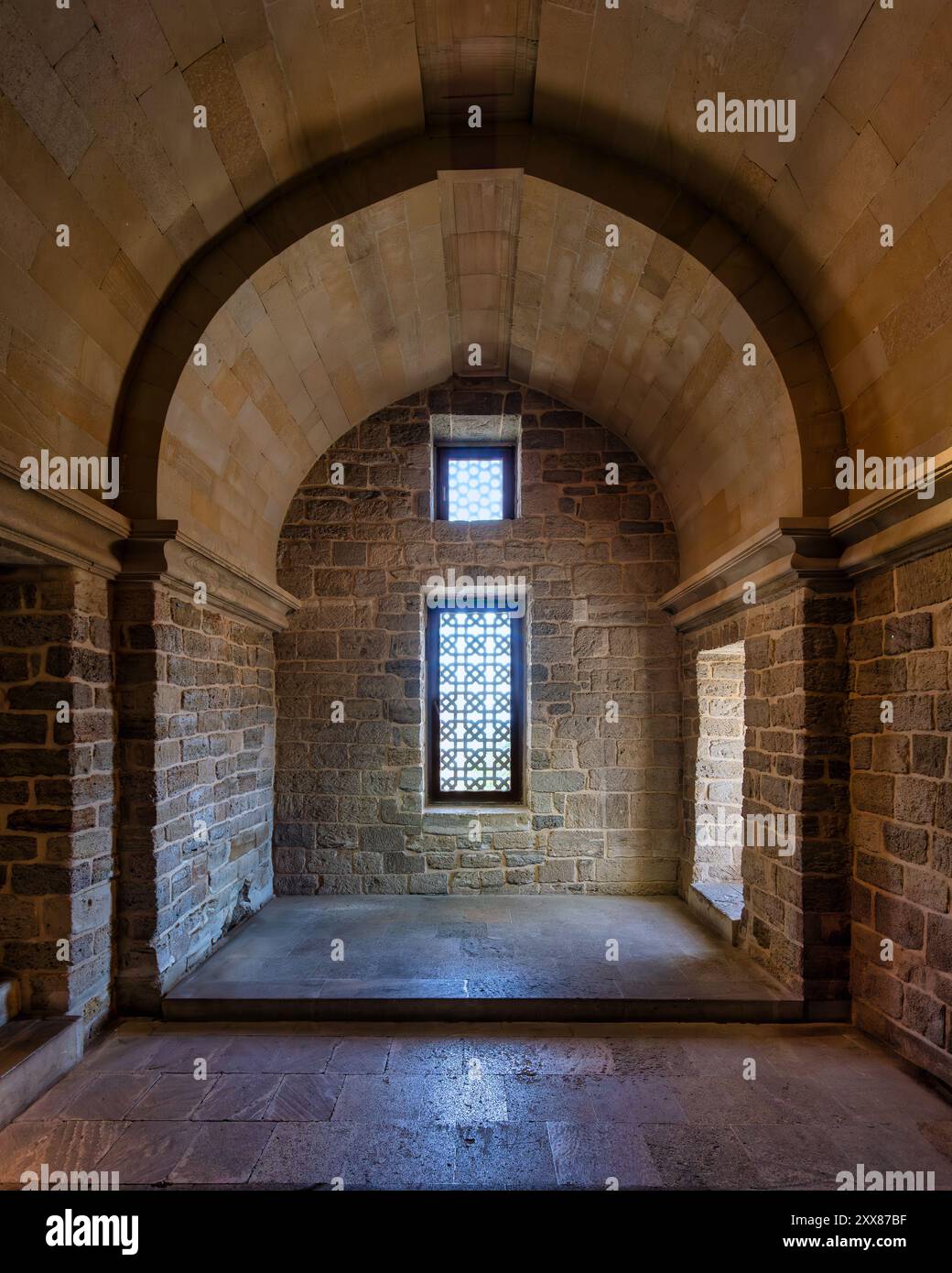 Inside a historic stone chamber, the sunlight filters through an ornate ...