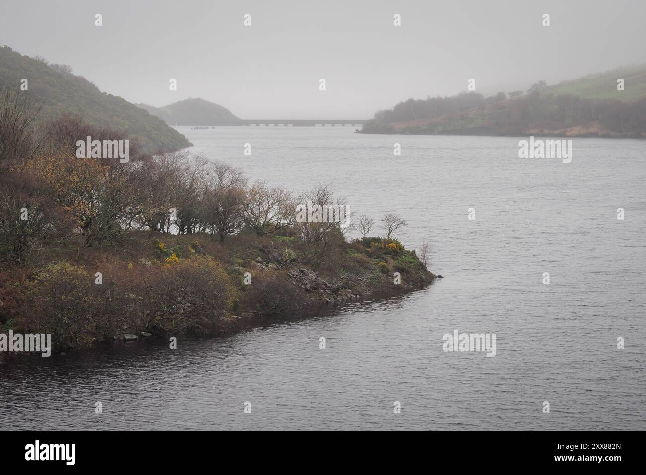 View down Meldon Reservoir with Dam in distance under low cloud ...