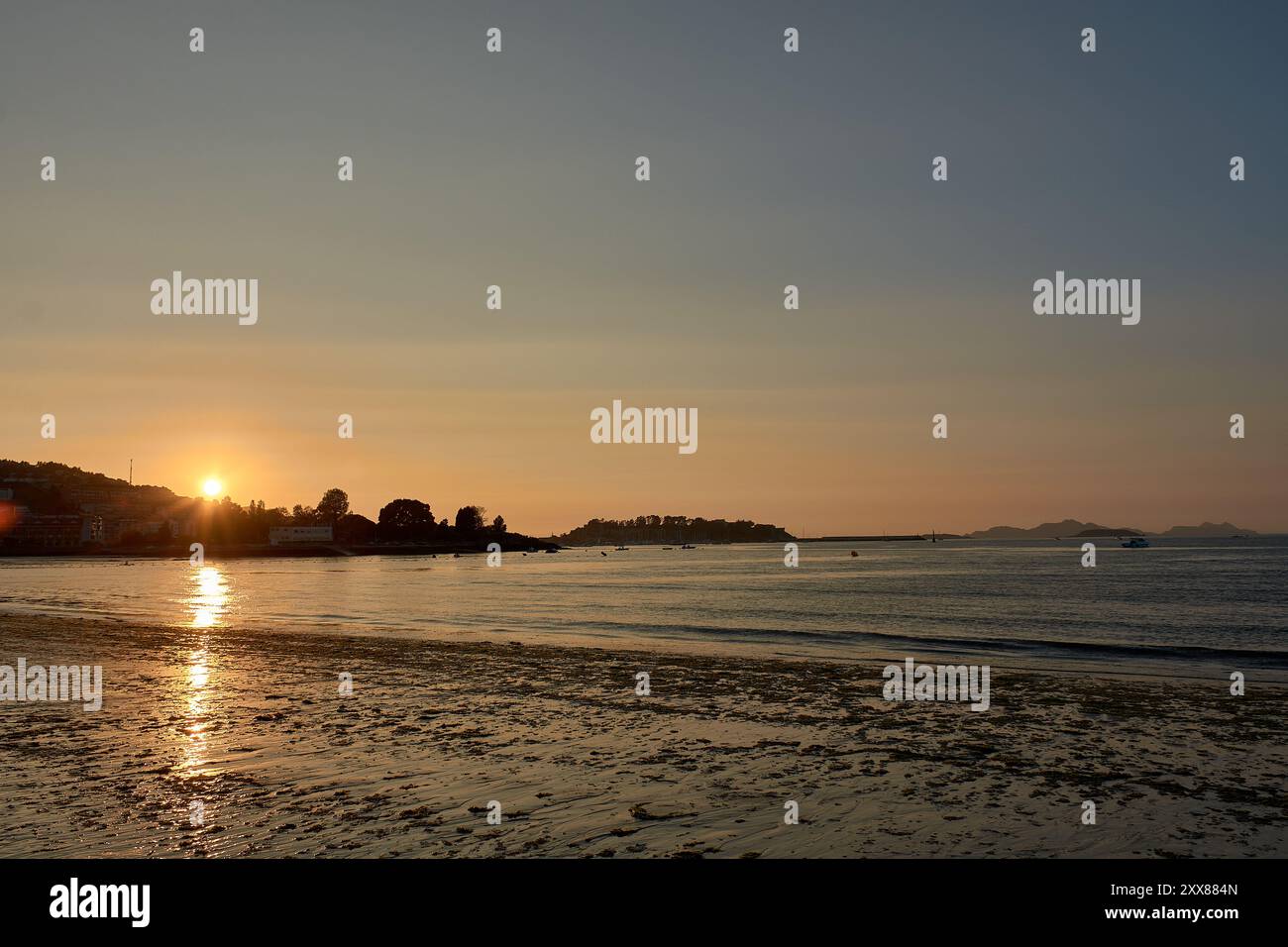 Extraordinary sunset at Ladeira Beach in Bayona, where vibrant orange ...