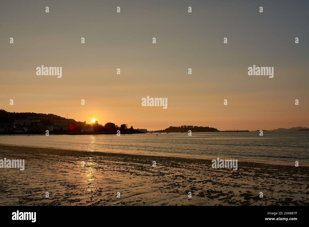 Extraordinary sunset at Ladeira Beach in Bayona, where vibrant orange ...