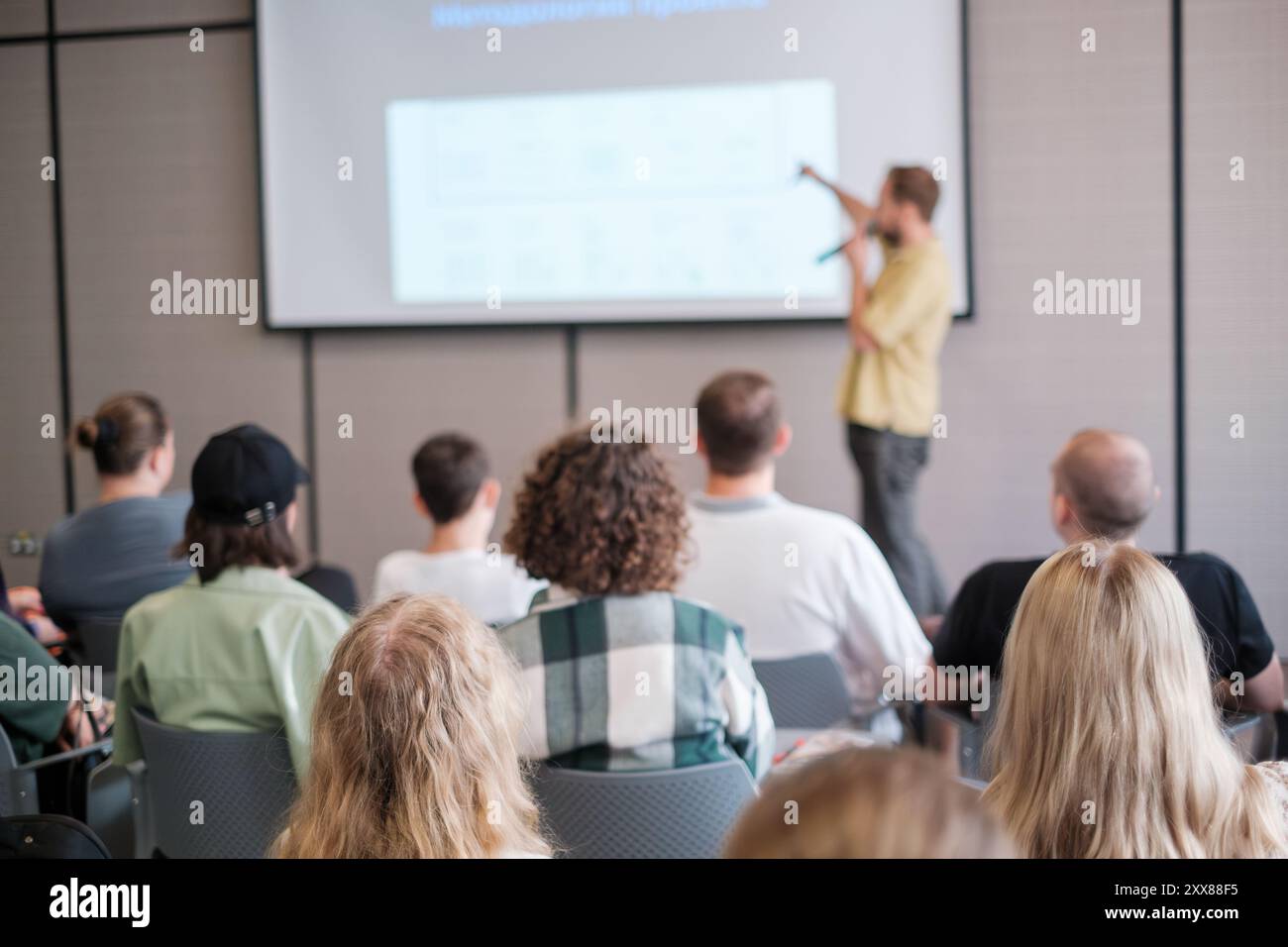 Group of people attentively listening to a speaker during a business ...