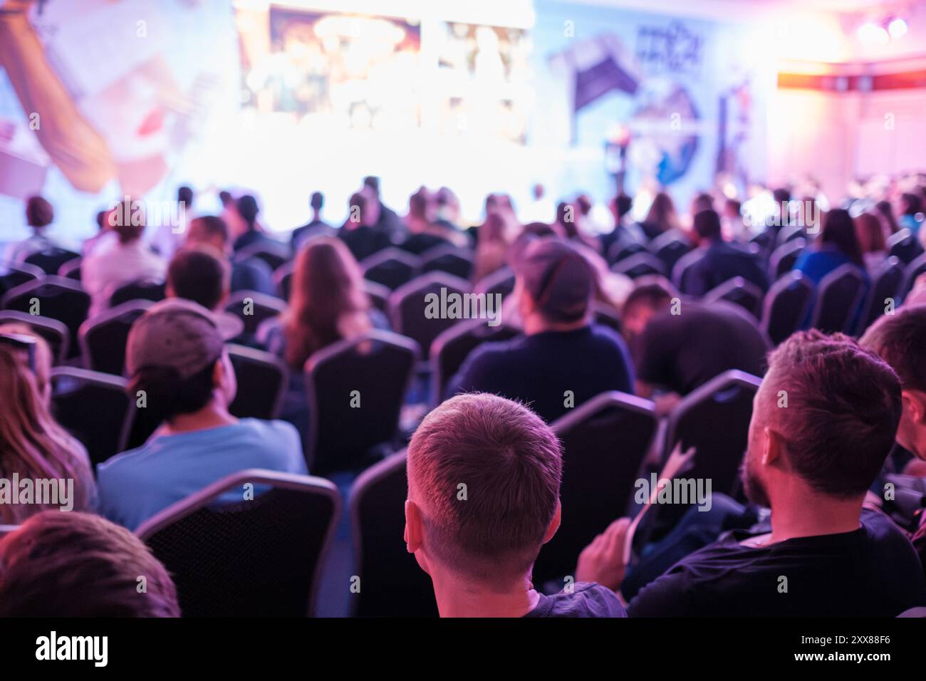 Large audience attentively listening to speaker at professional ...