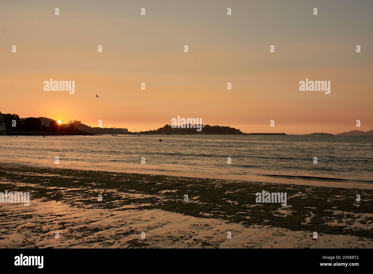 Extraordinary sunset at Ladeira Beach in Bayona, where vibrant orange ...