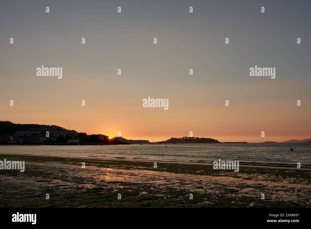 Extraordinary sunset at Ladeira Beach in Bayona, where vibrant orange ...
