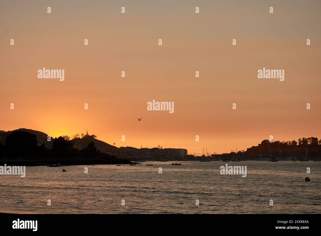 Extraordinary sunset at Ladeira Beach in Bayona, where vibrant orange ...