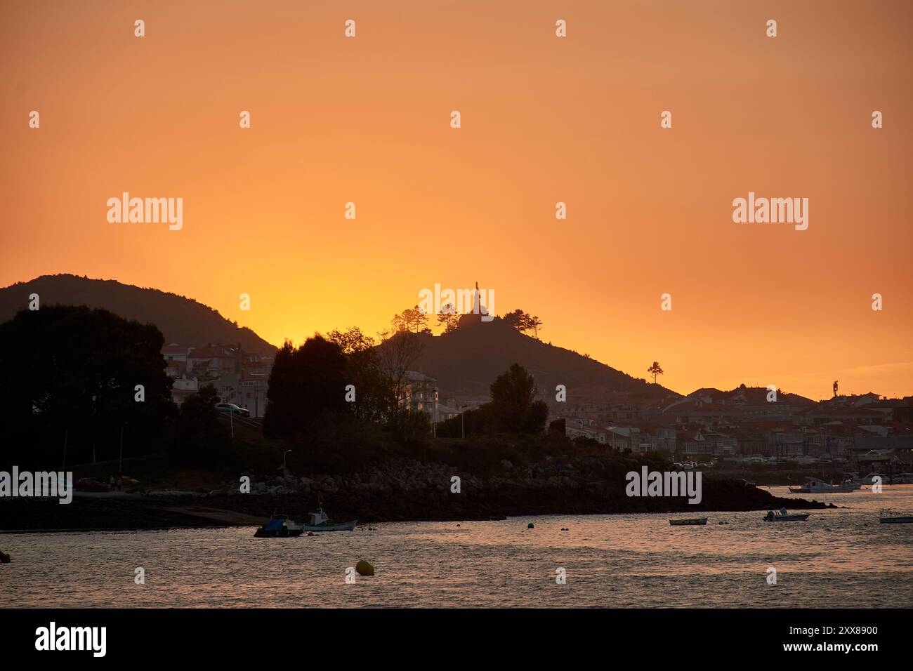 Extraordinary sunset at Ladeira Beach in Bayona, where vibrant orange ...