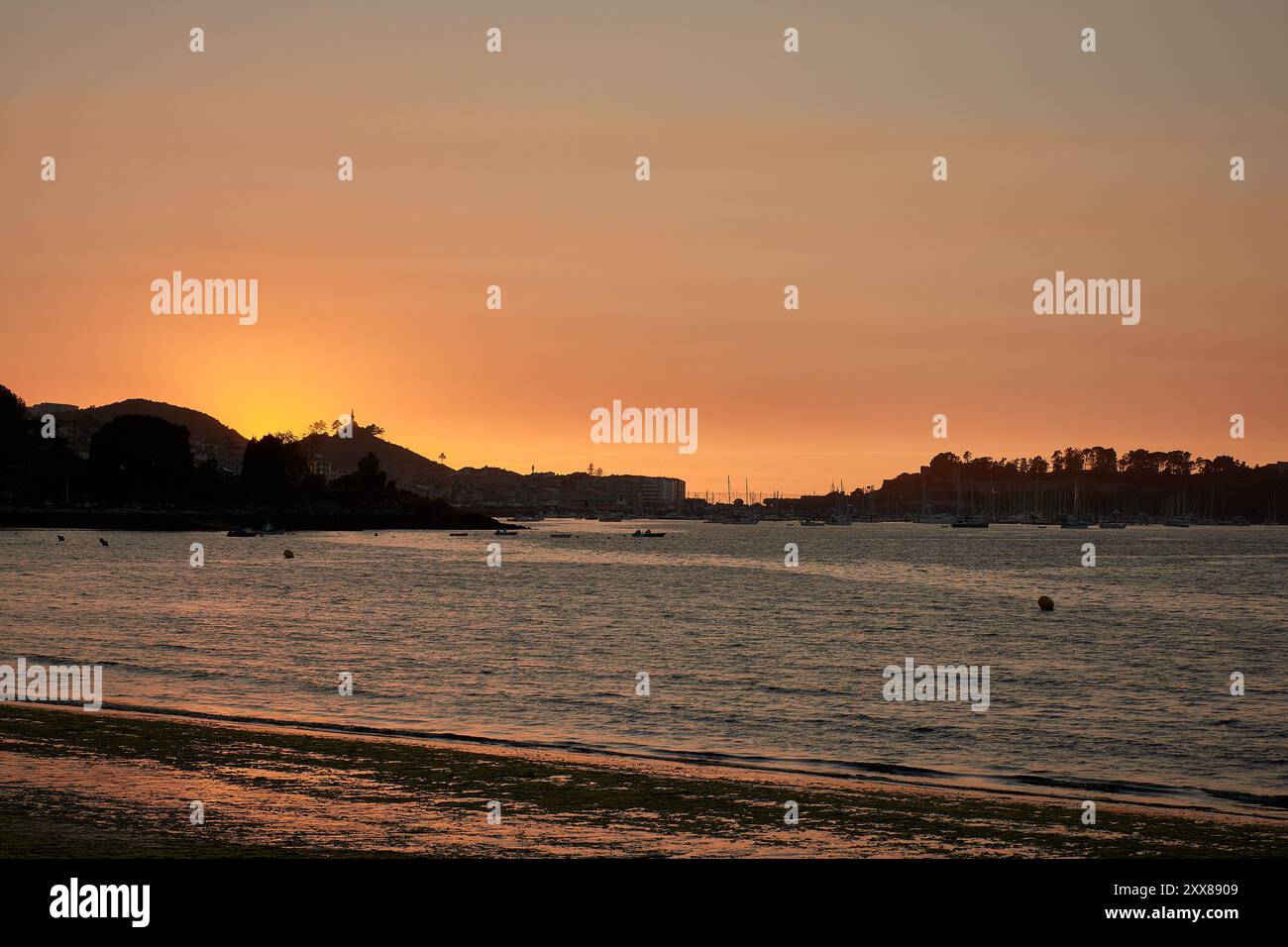 Extraordinary sunset at Ladeira Beach in Bayona, where vibrant orange ...