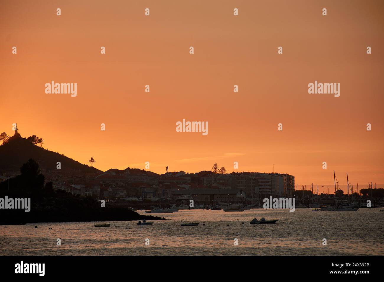 Extraordinary sunset at Ladeira Beach in Bayona, where vibrant orange ...