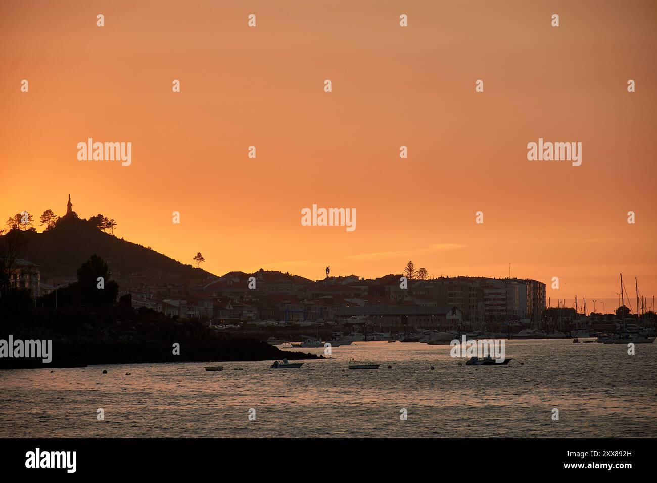 Extraordinary sunset at Ladeira Beach in Bayona, where vibrant orange ...