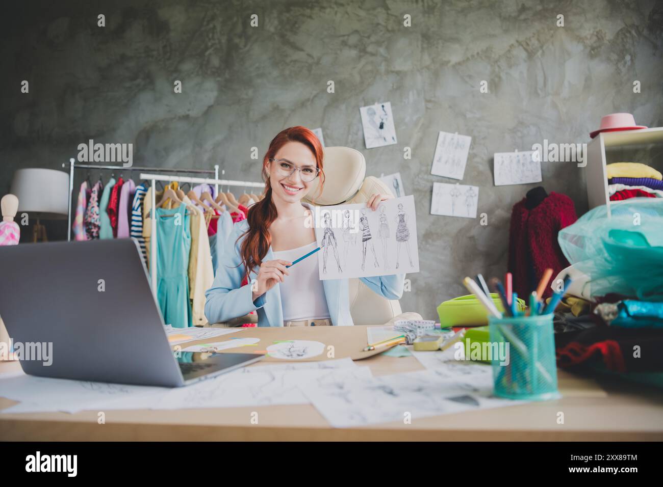 Photo of positive shop assistant girl sit table online meeting showing ...