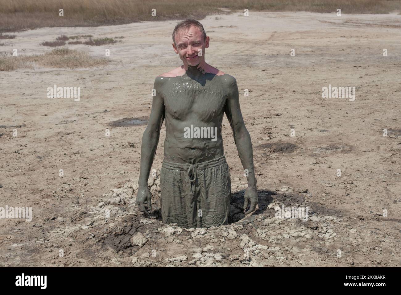 Man in mud geyser resort outdoor Stock Photo - Alamy