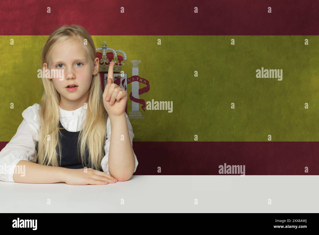 Clever blonde young child girl an Spanish flag background. Education in ...