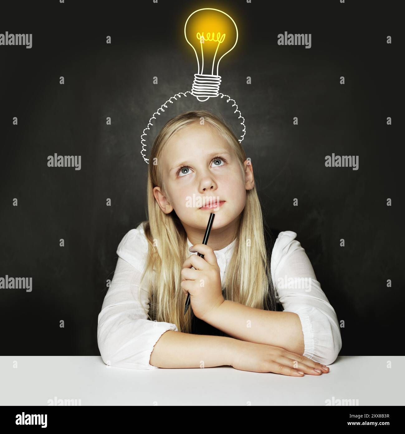 Dreaming child girl student with yellow light bulb on school blackboard ...
