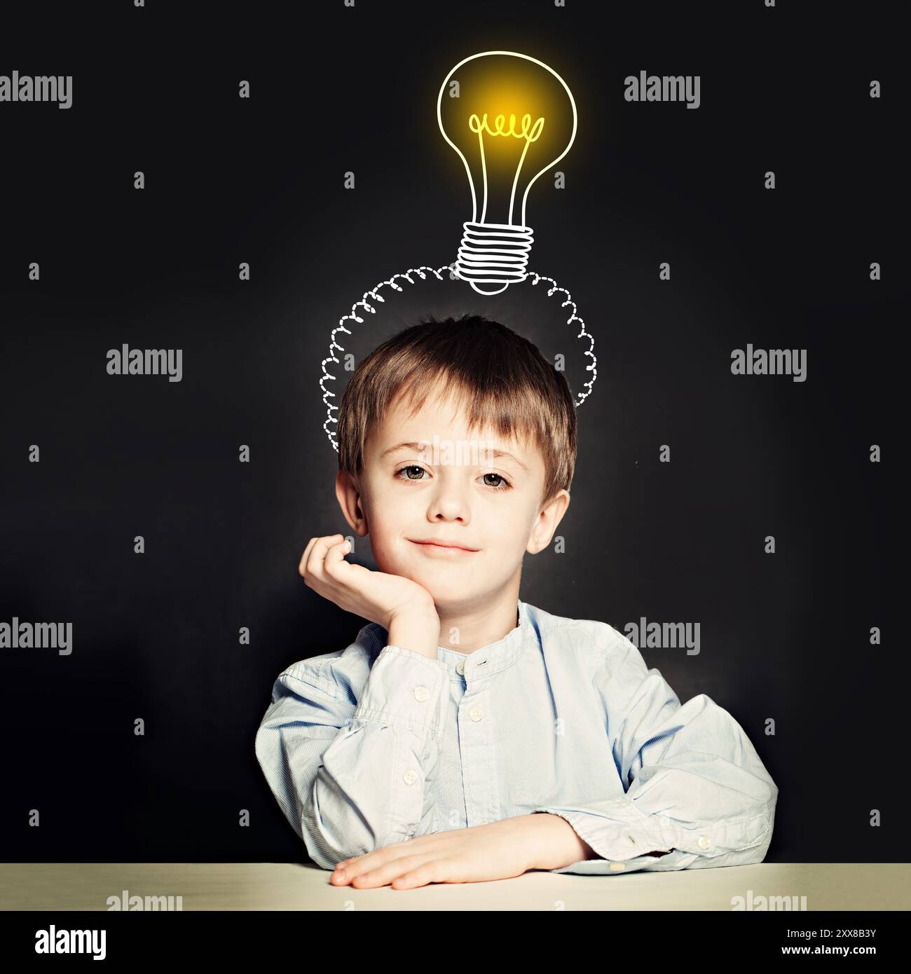 Clever child boy student with yellow light bulb and question marks on ...