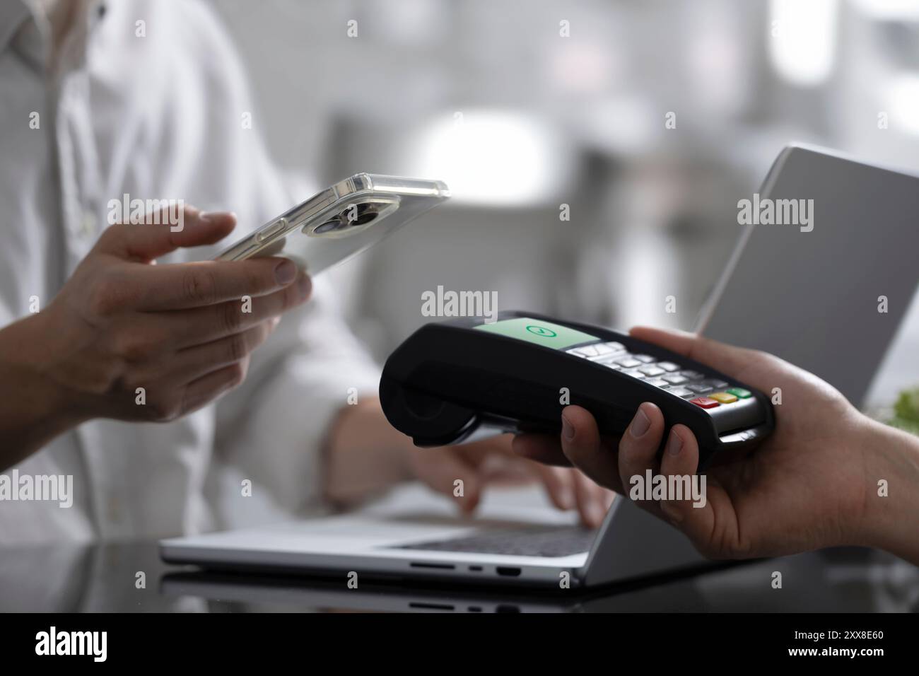Contactless payment, a man pays for a purchase in the cabin of an airplane. High quality photo ...