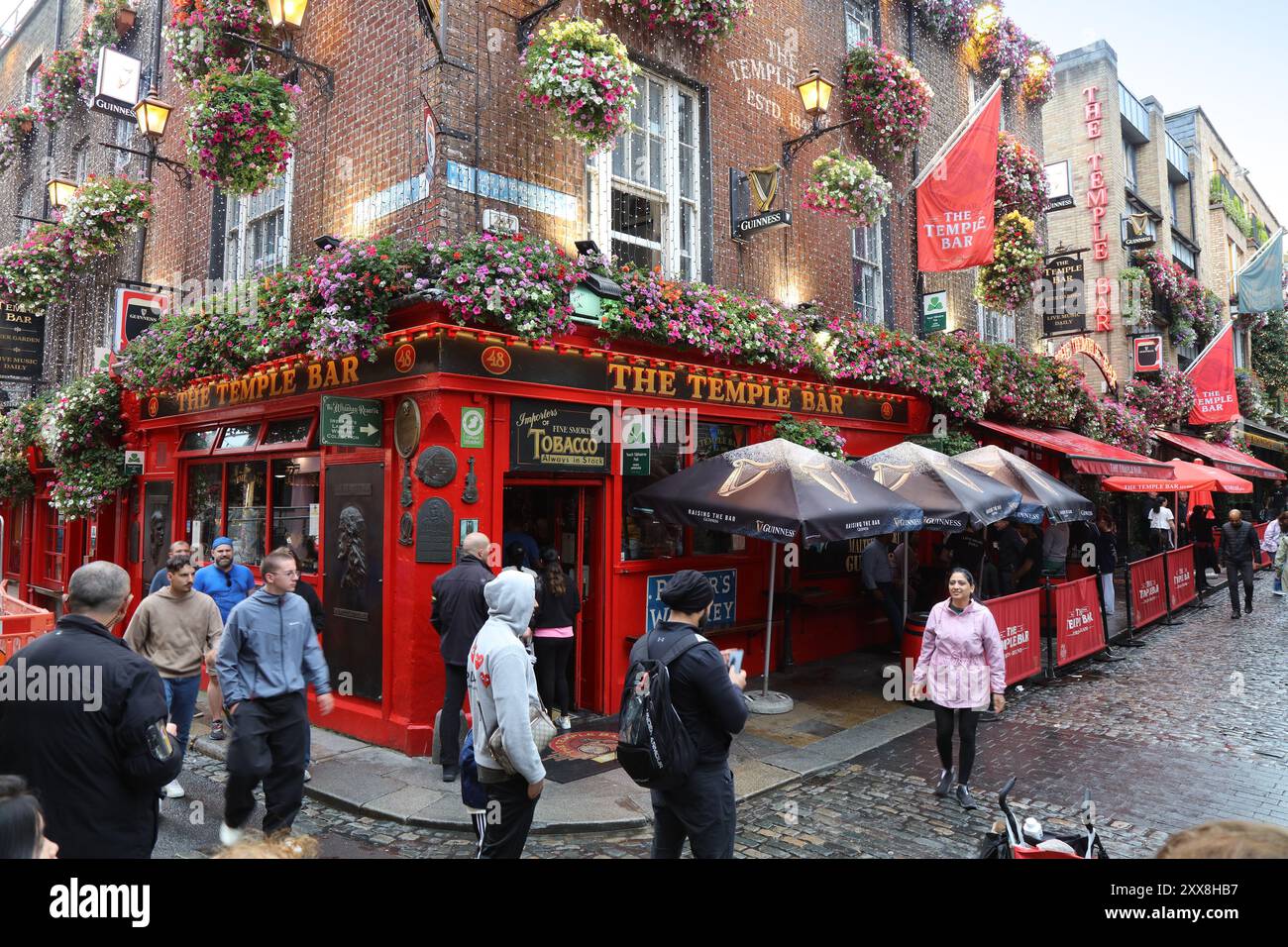 DUBLIN, IRELAND - JULY 5, 2024: People visit The Temple Bar, famous pub ...