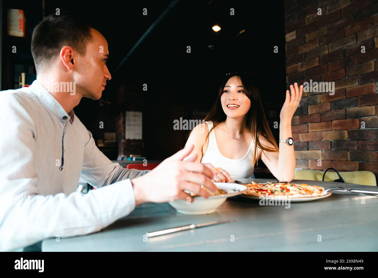 Coworker couple having lunch together Stock Photo - Alamy