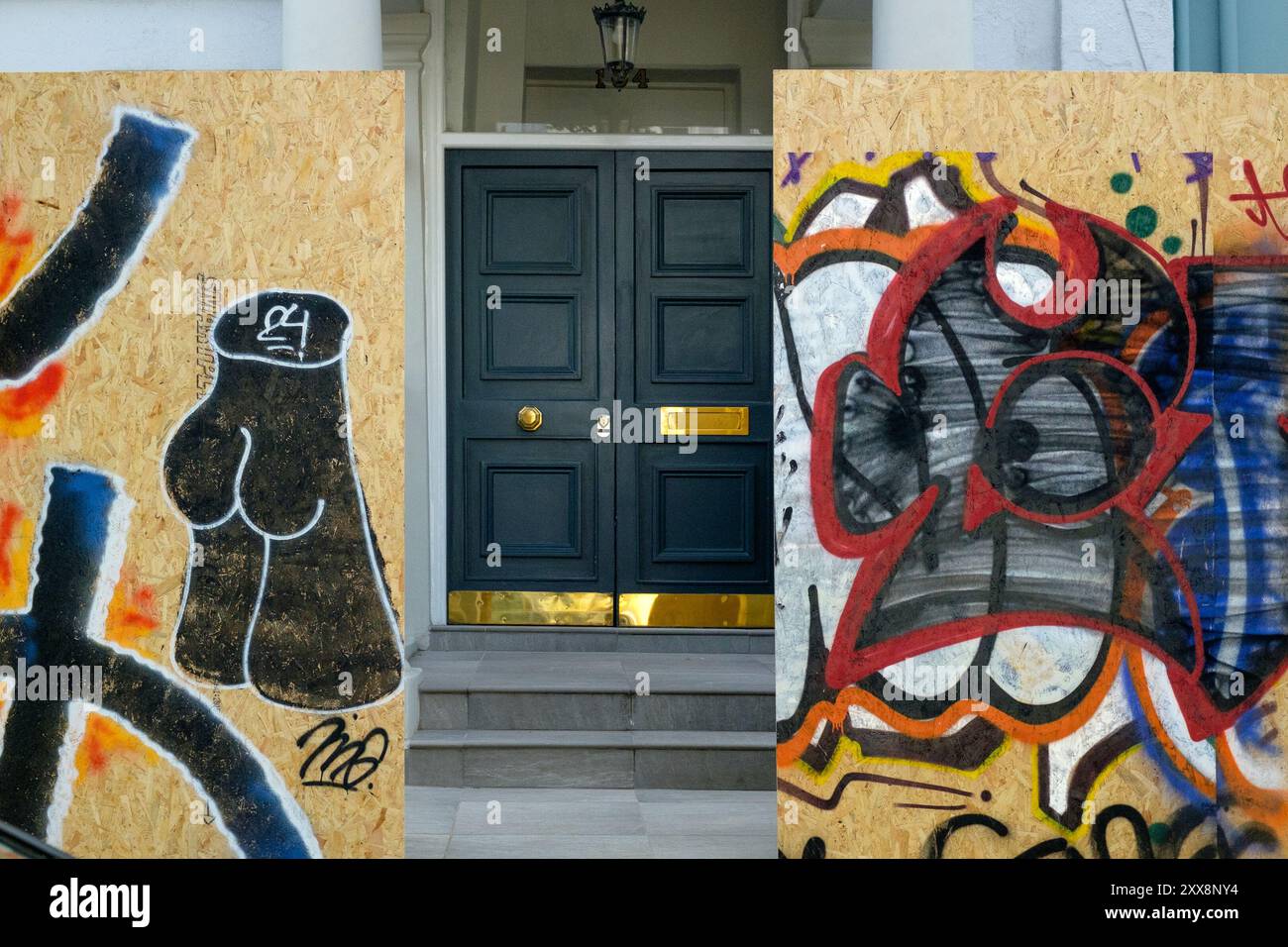 London, UK. Hoarding being put up to protect multimillion pound houses ...