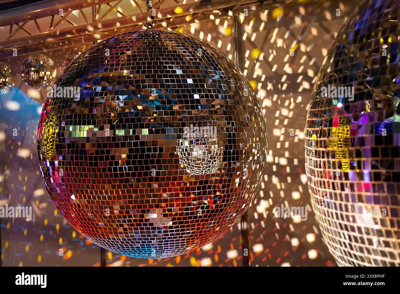 Rainbow disco balls with disco lights. Entertainment industry Stock ...