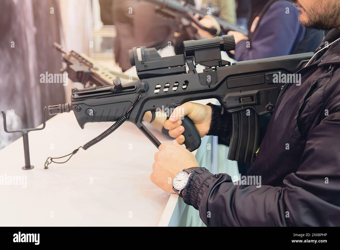 Buyer selects an automatic rifle in a gun store. Self-defense Stock ...