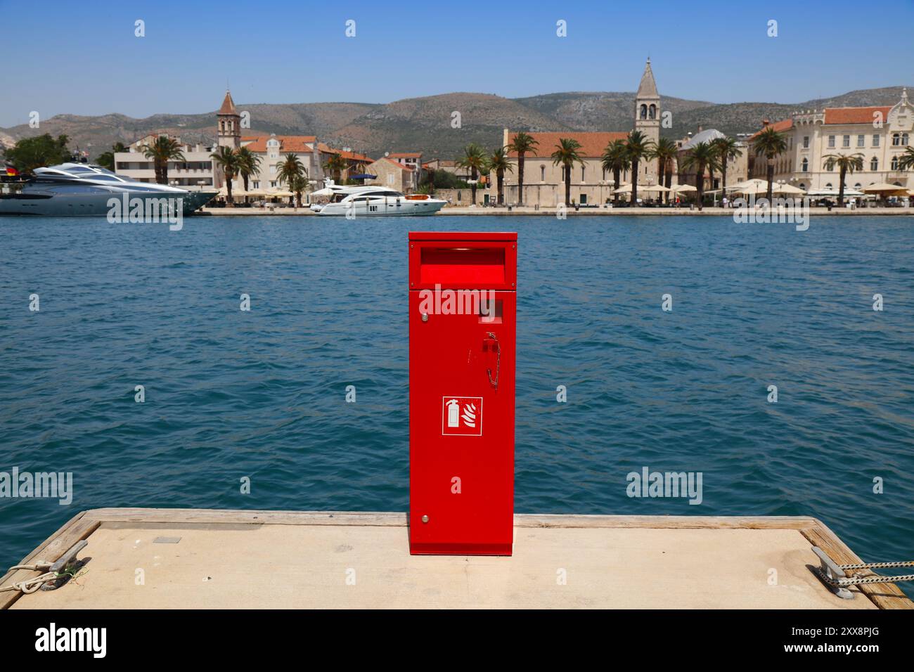 Fire extinguisher box pedestal in Trogir harbor, Croatia Stock Photo ...