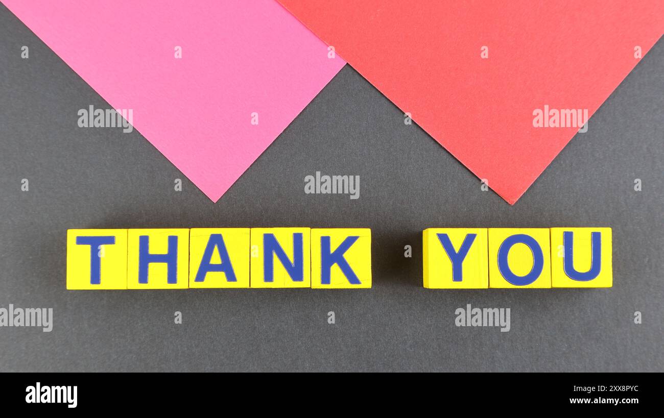 Thank you word above wooden cubes style and black background with red ...
