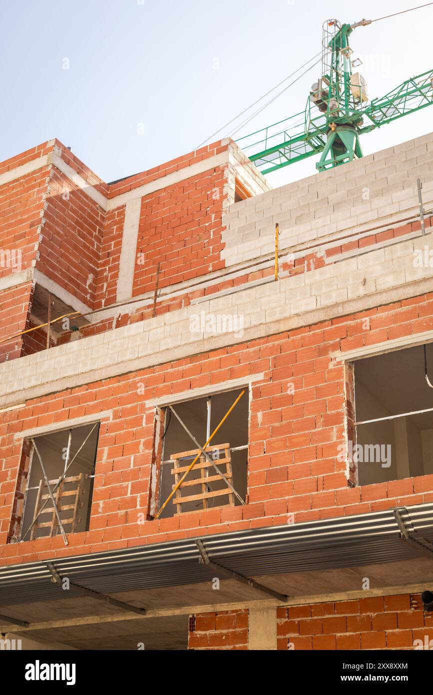 Detailed view of a building under construction, showcasing red brick ...