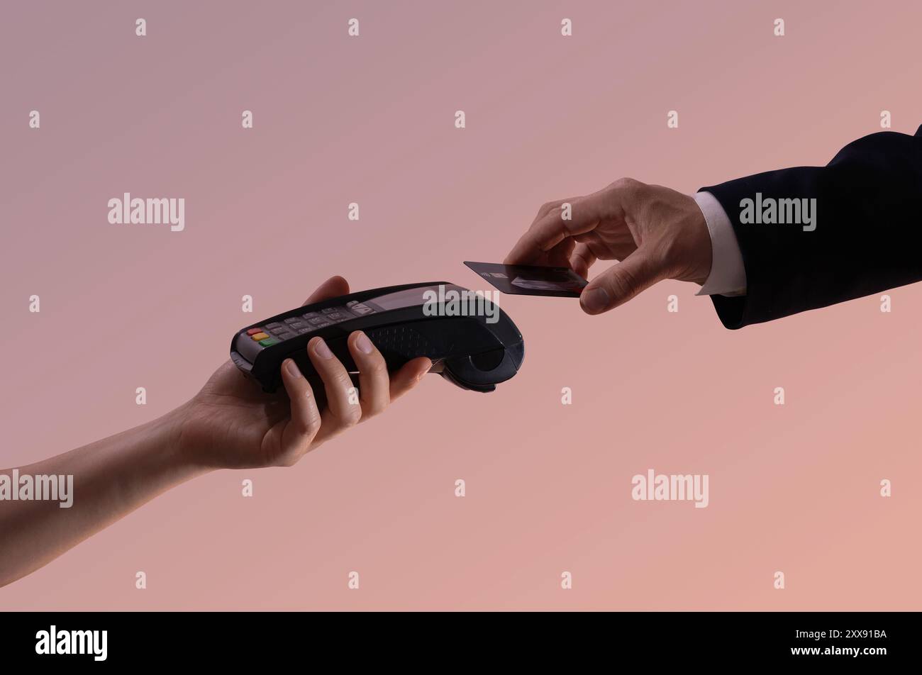 Two hands are shown engaging in an electronic payment on a uniform ...