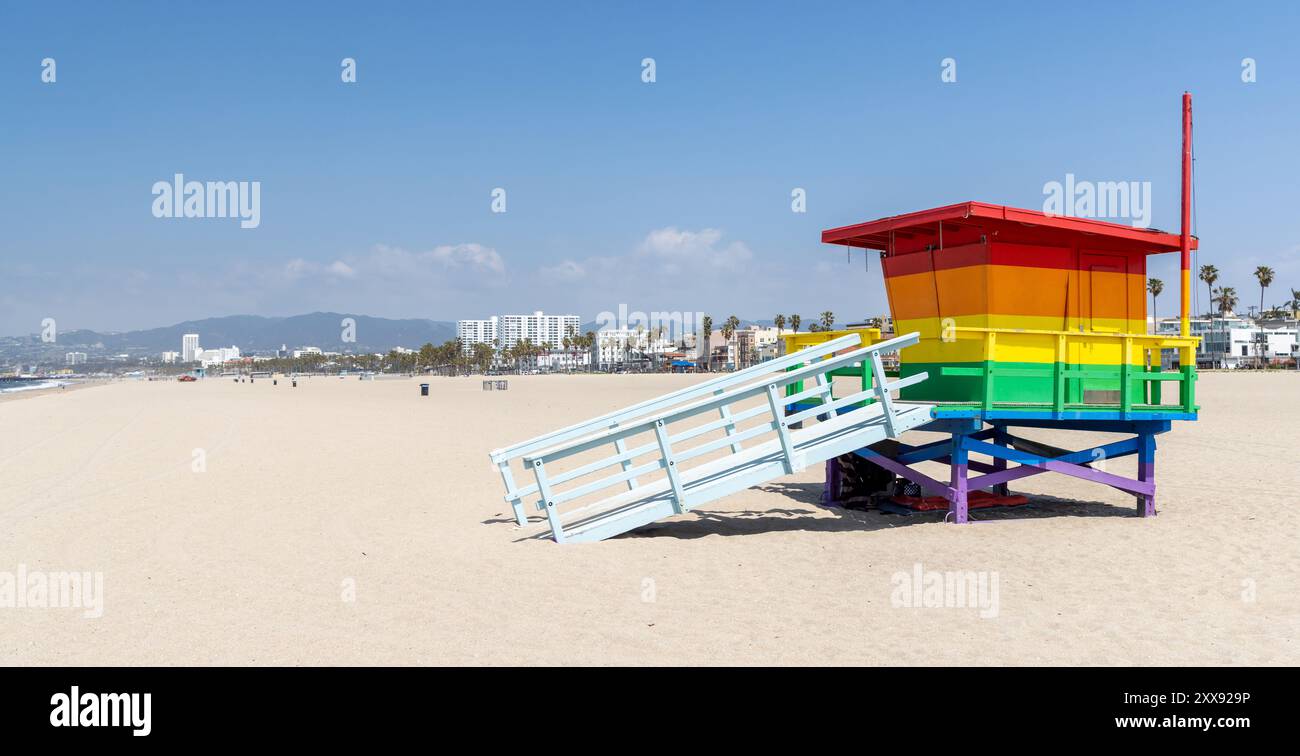 A vibrant photo of a lifeguard tower in the colors of the pride flag ...