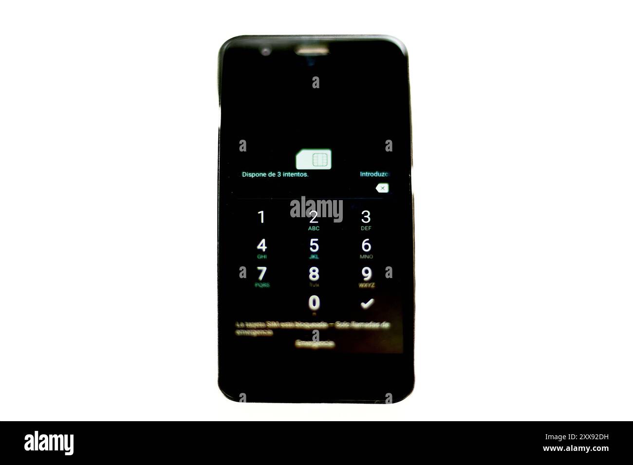 Photograph of a smartphone with an illuminated numeric keypad display ...